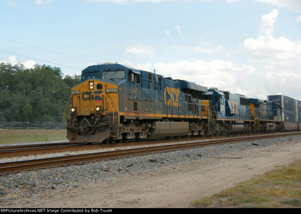 CSX 5441, 8538, and 581 heading North with a train of loaded well cars